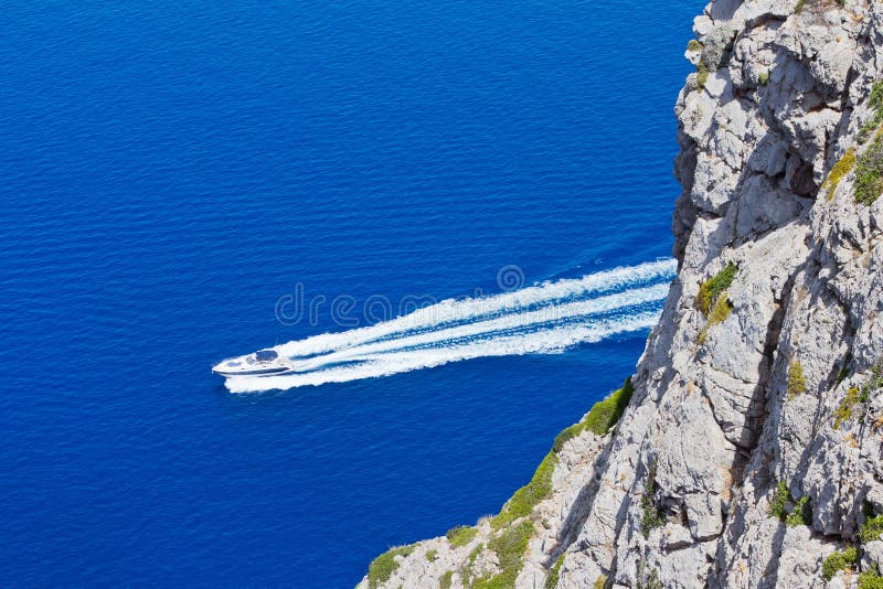 Cliff coast with boat stock image. Image of speed, spain - 28947557