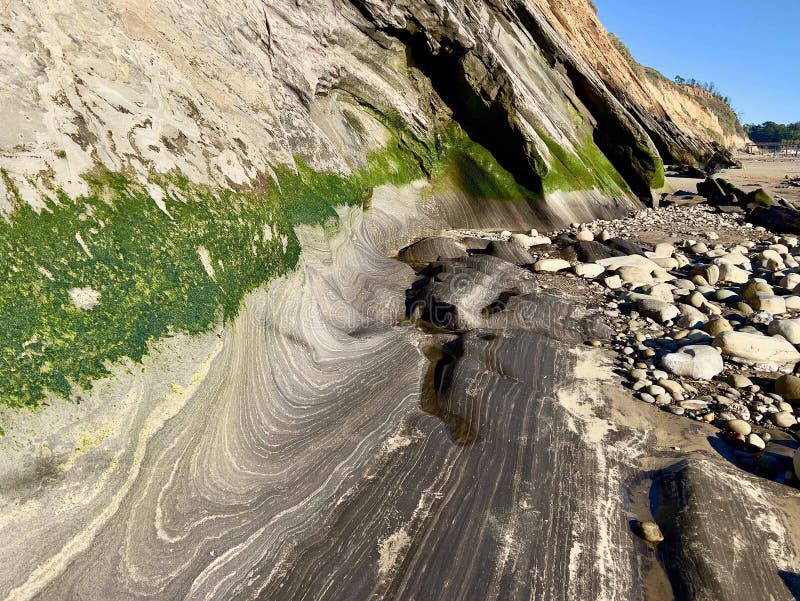 Cliff Covered by Moss Surrounded by Rocks Stock Photo - Image of ...