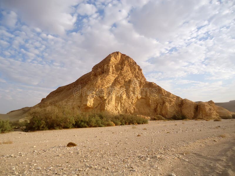 Cliff in the Desert Against a Blue Sky with Clouds Stock Photo - Image ...