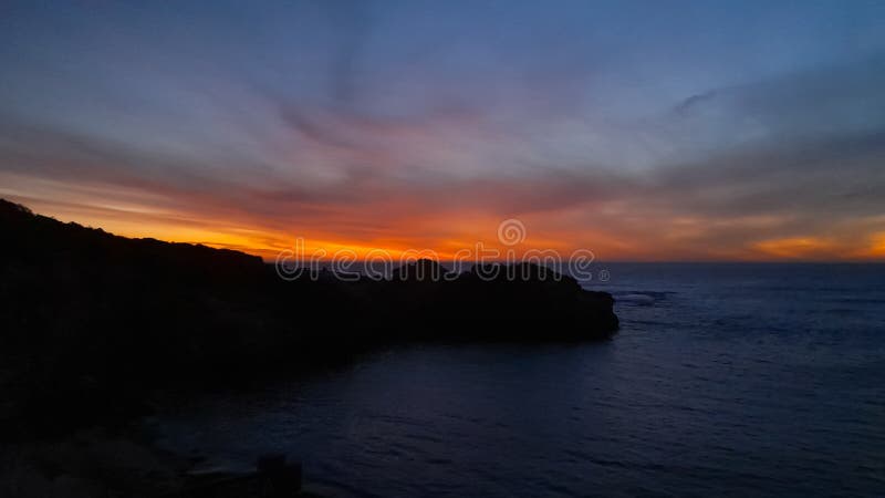Cliff in the Evening after Sunset at Beach with Orange Sky Stock Photo ...