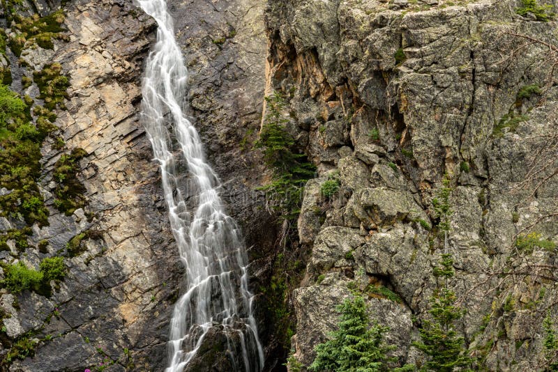 Cliff Face and Cascading Creek Run Down Mountain Side Stock Photo ...