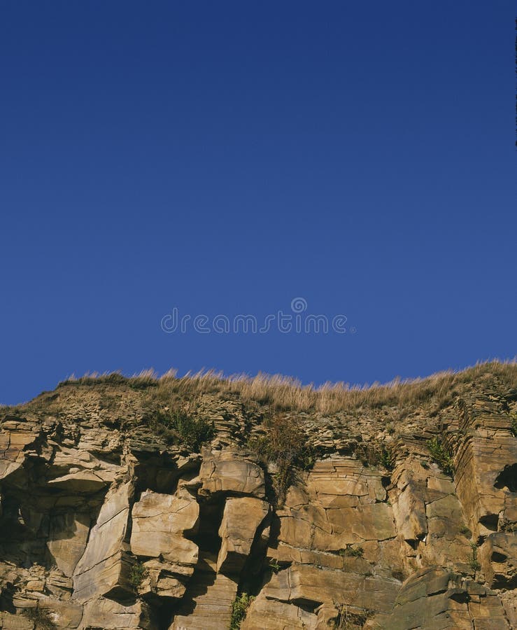 CLIFF FACE and GRASS with BLUE SKY Stock Photo - Image of nature ...