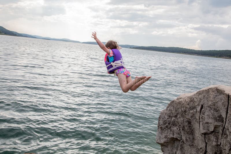 Cliff Jumping stock image. Image of child, lifejacket - 41548405