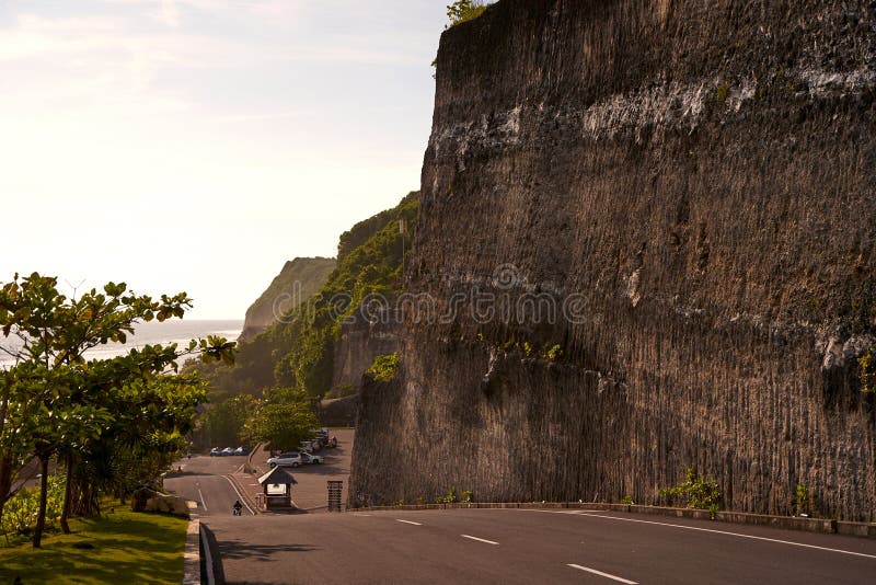 The Cliff Overhangs Along the Road To the Ocean at Sunset Stock Photo ...