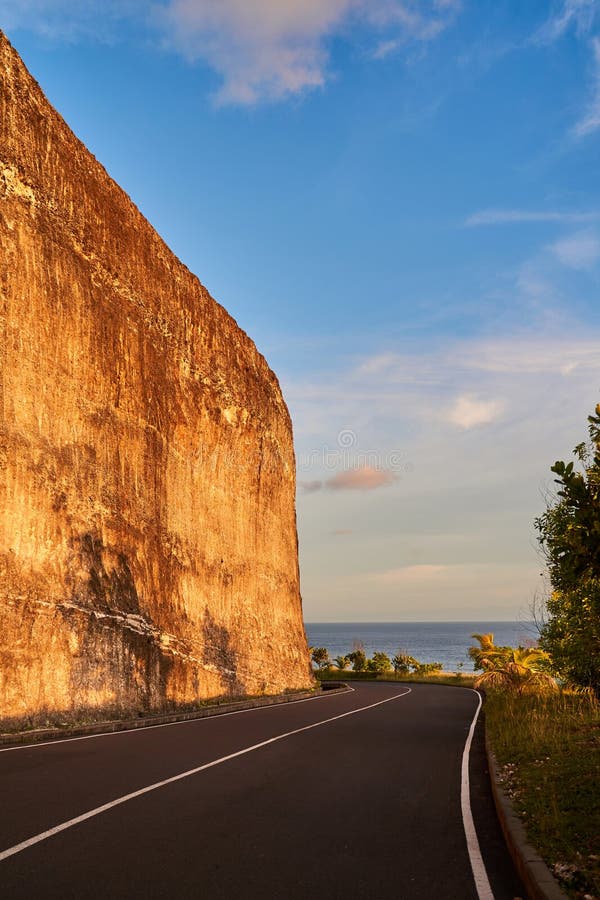 The Cliff Overhangs Along the Road To the Ocean at Sunset Stock Image ...