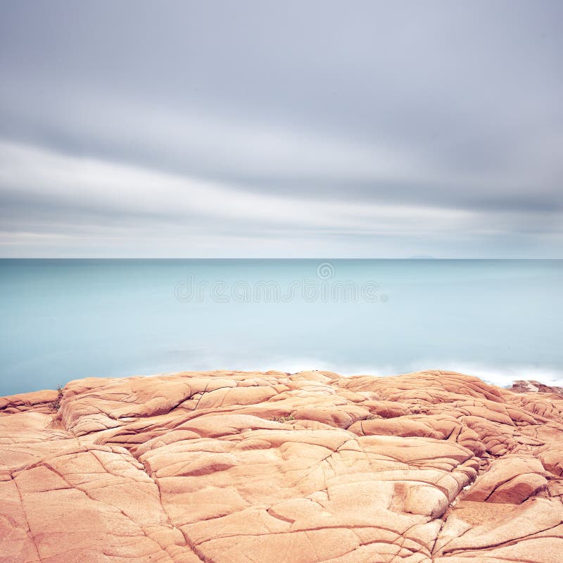 Rocks in a Blue Ocean Waves Under Cloudy Sky in a Bad Weather. Stock ...