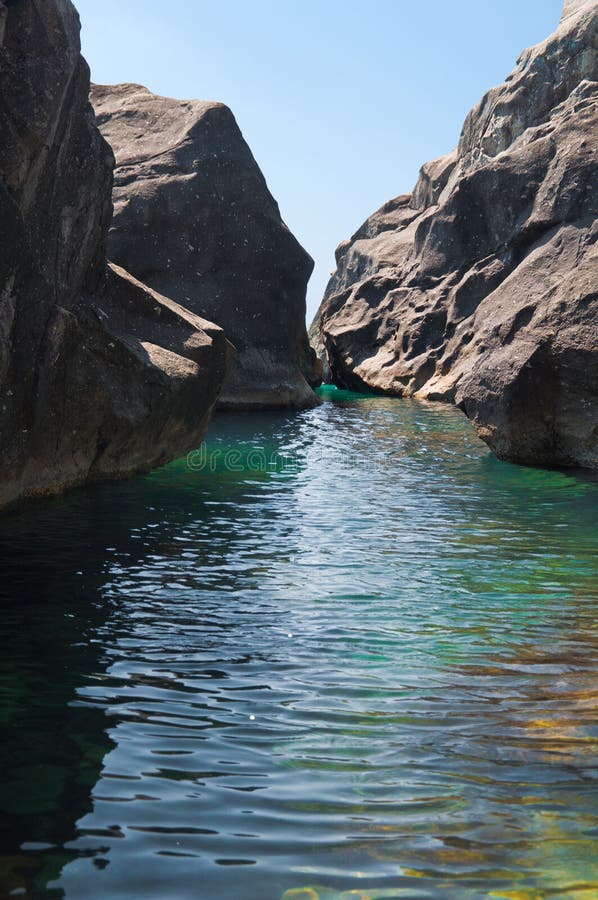 Cliff rocks tunnel stock image. Image of reef, color - 27342075