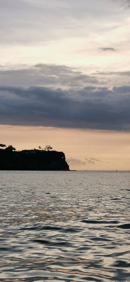 Cliff side over the ocean stock photo. Image of dawn - 261591124