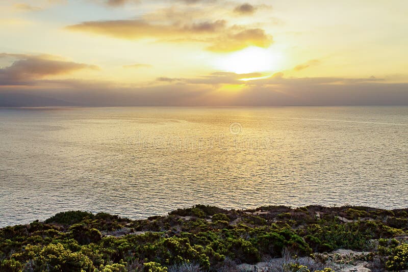 Cliff Side View of Pacific Ocean at Sunrise with Sunrays Stock Photo ...