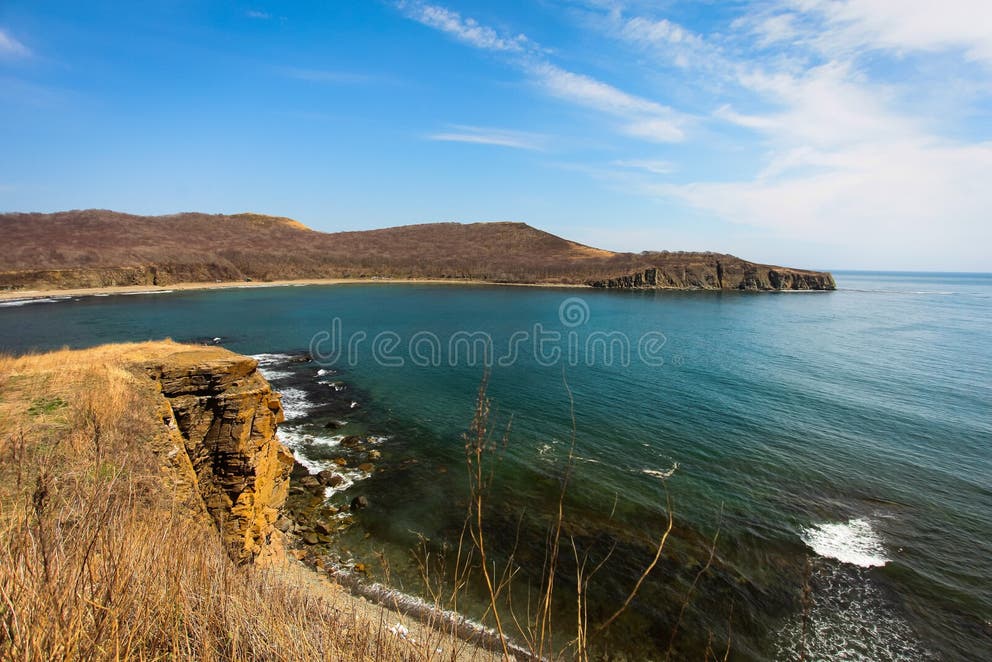 Cliff on Spring Time with the Deep Blue Sea and Sky with Clouds Stock ...