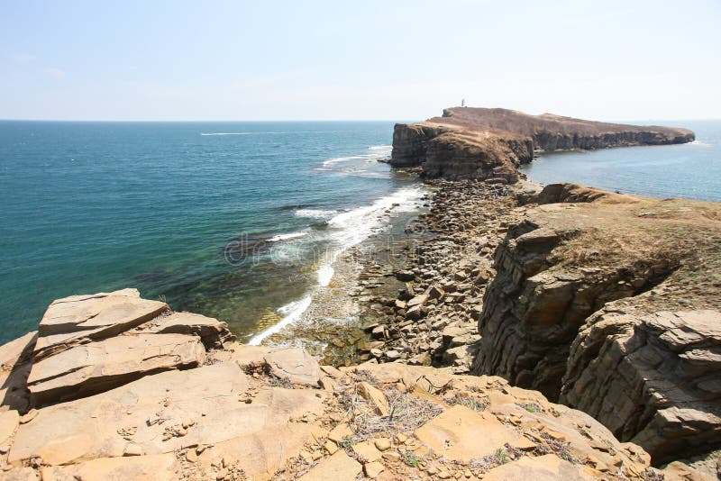 A Man on Top of a Cliff in the Spring Mountains at Sunset and Enjoying ...