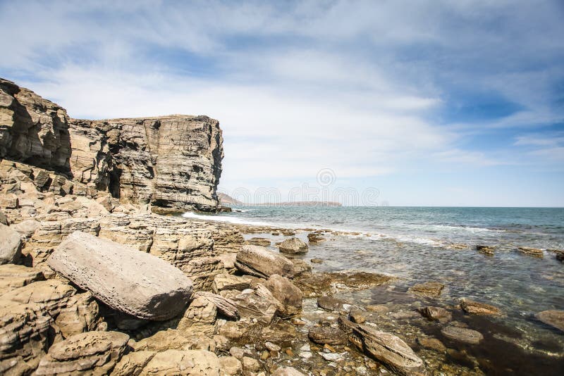 Cliff on Spring Time with the Deep Blue Sea and Sky with Clouds Stock ...