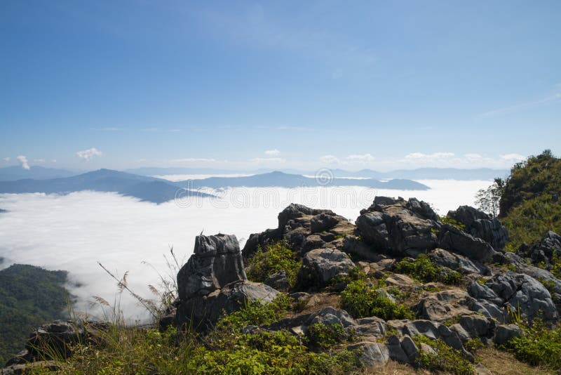 Cliff at the Valley and Mountains with Mist in the Daylight Stock Image ...