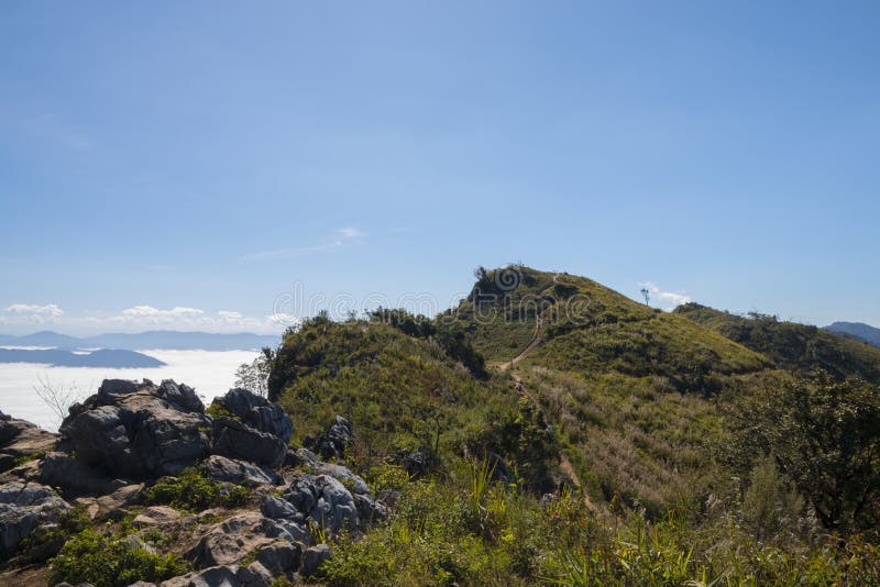 Cliff at the Valley and Mountains with Mist in the Daylight Stock Photo ...