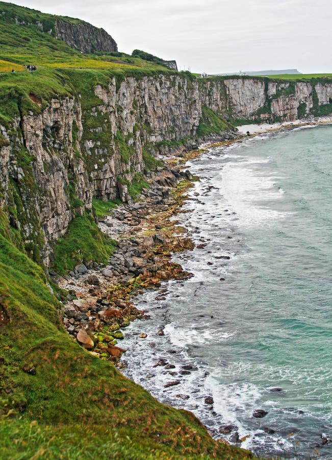 Cliffs Along Irish Coast Next To Tiny Carrick-a-rede Island Stock Photo ...