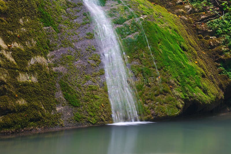Cliffs Overgrown with Moss with Waterfall Flowing Down Stock Image ...