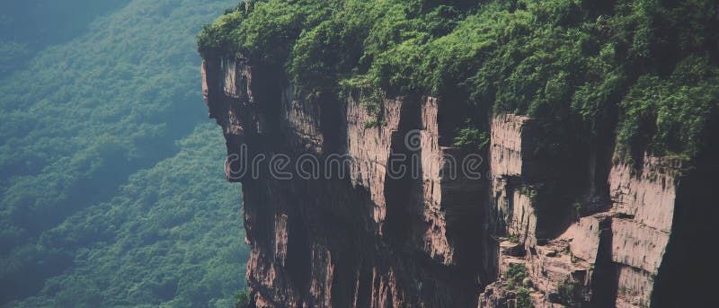 Cliffs Rise Dramatically with Layered Rock Formations and Lush Greenery ...