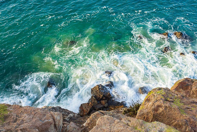 Cliffside View of Wave and Foam Breaking on Rocks at Cliff Base Stock ...