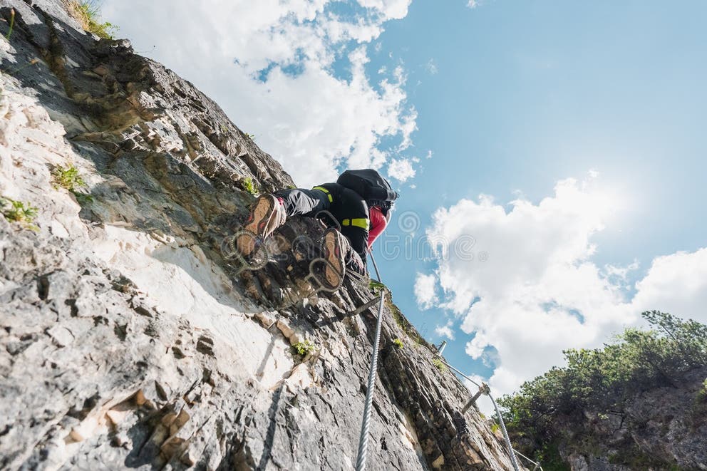 Climber Climbing Up the Steps of a Via Ferrata Climbing Path Stock ...