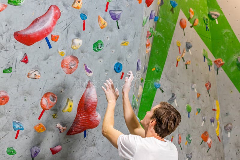Climber Explores and Develops a Route on a Climbing Wall in the Boulder ...
