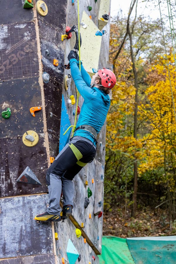 Climber with Ice Tools Climbing on Artificial Ice Climbing and ...