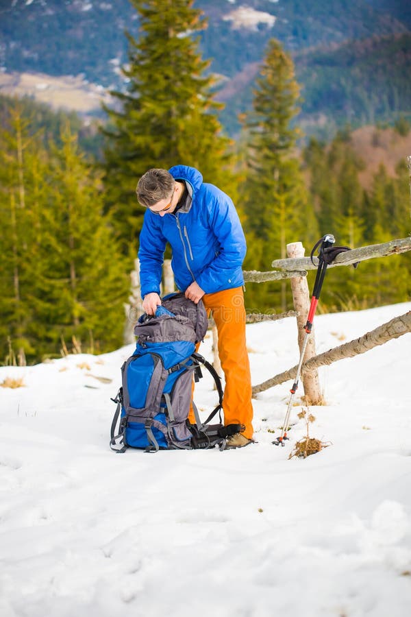 The Climber Pulls Things Out of the Backpack. Stock Photo - Image of ...