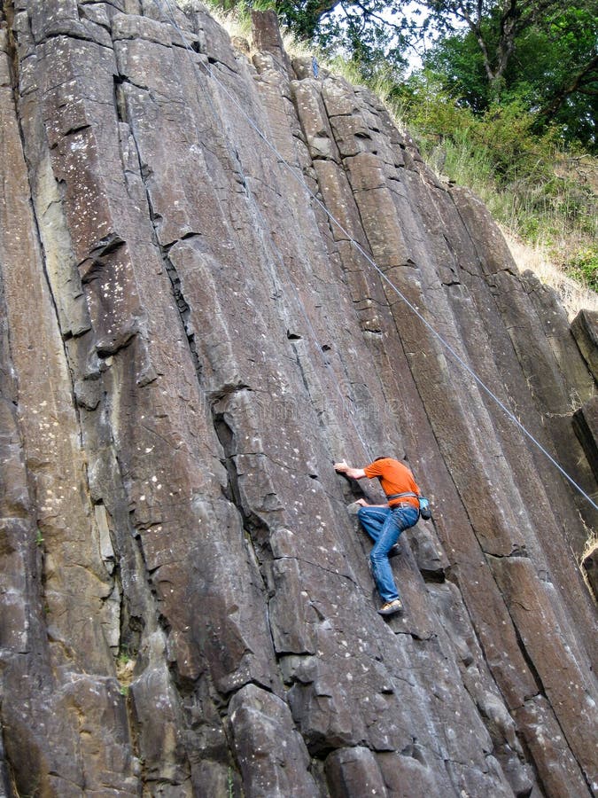 A Climber Scales the Columns Basalt Cliff in Eugene, Oregon Stock Photo ...