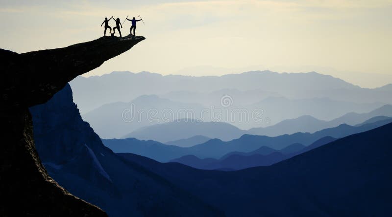 Climbers On Edge Of Mountain Summit Stock Photo - Image of people ...