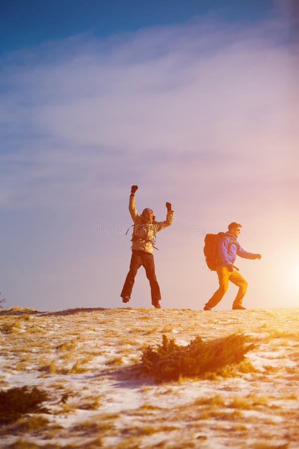 Climbers jumping for joy. stock photo. Image of backpack - 76280830