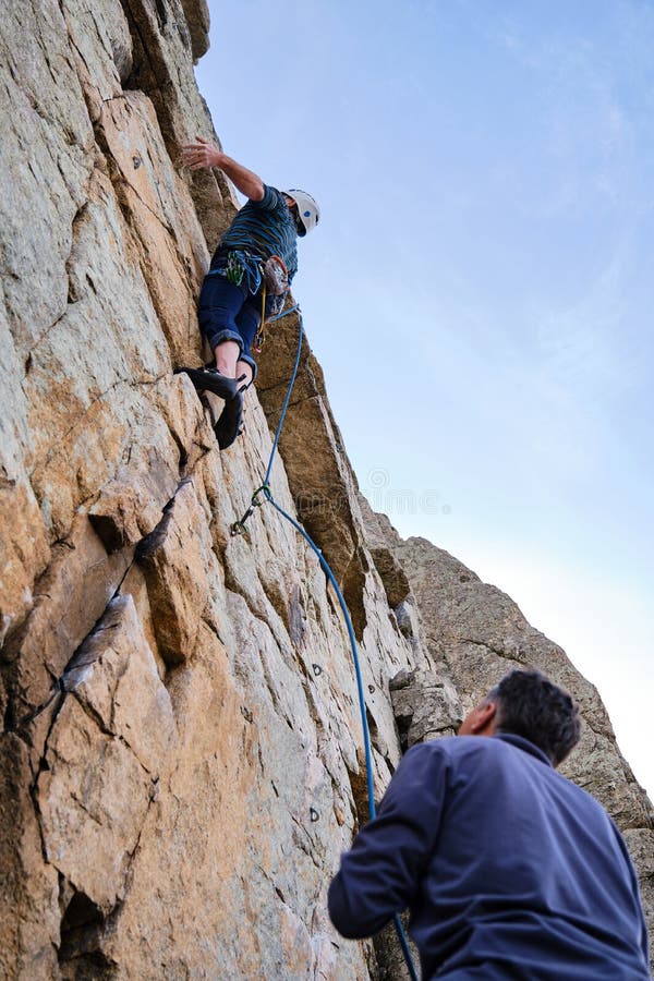 A Climbers Practicing Rock Climbing on a Rock Face. Stock Photo - Image ...