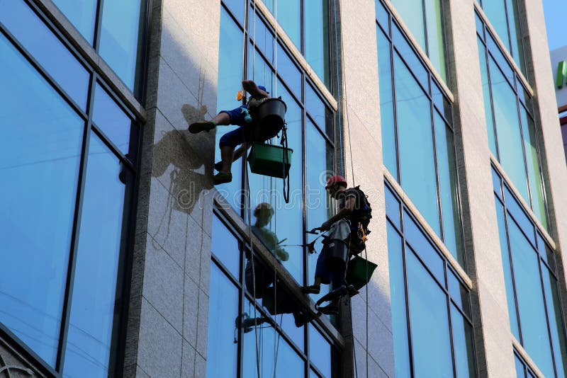 Climbers washing windows stock photo. Image of work - 164816192