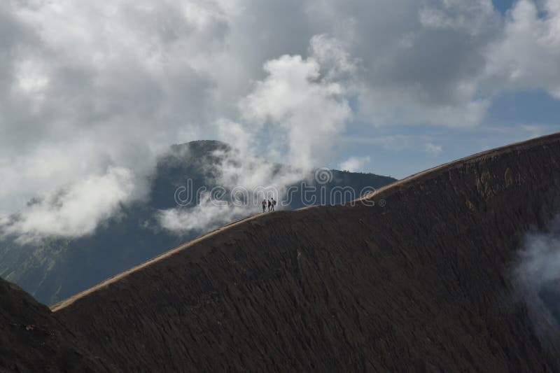 Climbing on the Peak of a Mountain with a Cloud Background Stock Photo ...