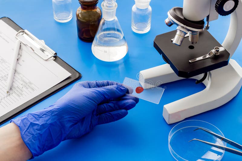 Clinical Science Research with Microscope. Hand Writes Test Results on ...