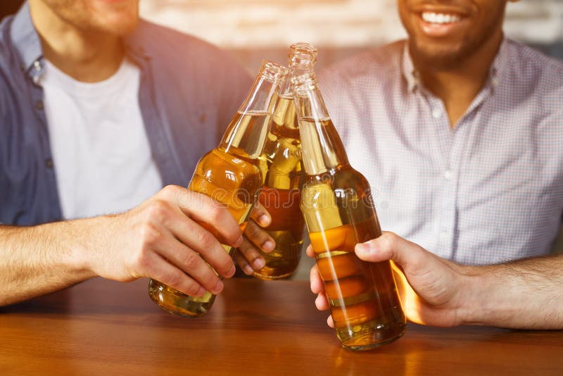 Clinking Bottles of Beer. Men Having Rest in Pub Stock Photo - Image of ...
