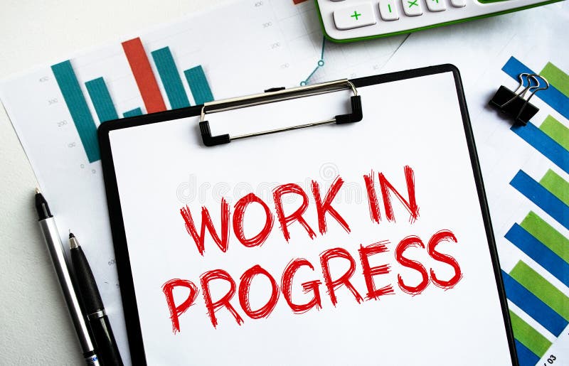 A Clip-on Folder Labeled WORK in PROGRESS. Top View of a Desktop Along ...