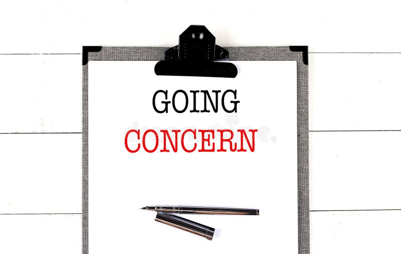 Clipboard with the Words Going Concern and a Silver Pen on a White ...