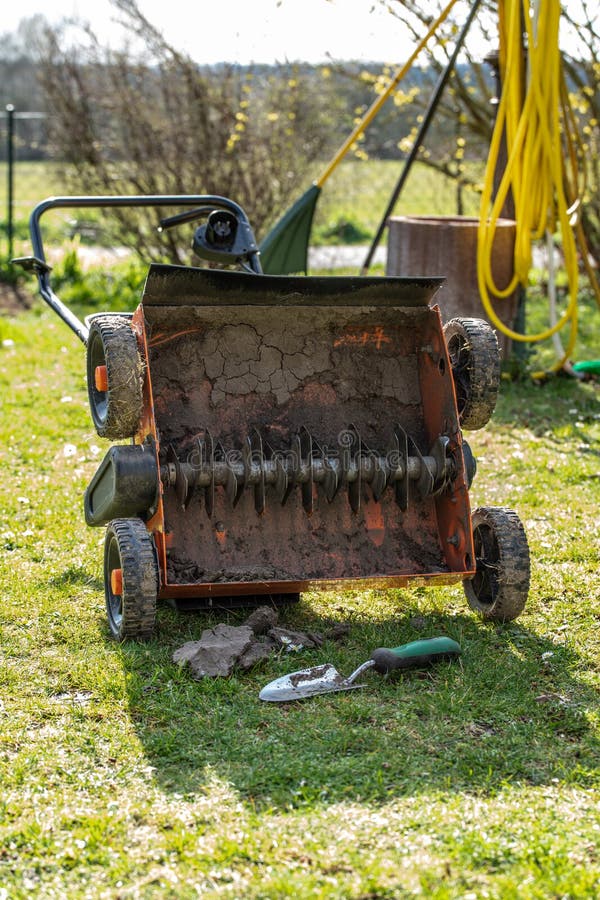 Clleaning a Lawn Thatcher in the Garden Stock Photo - Image of cleaning ...