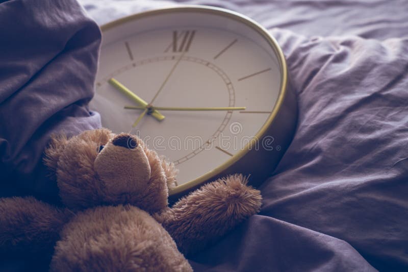 Clock in bed on a blanket stock image. Image of morning - 187169667