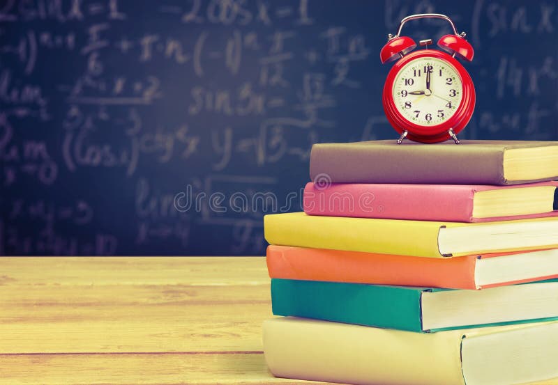 Stack of Books and Alarm Clock on Wooden Table Stock Photo - Image of ...