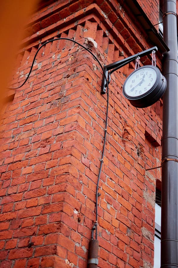 Clock on a Brick Building on the Street Hanging Stock Image - Image of ...