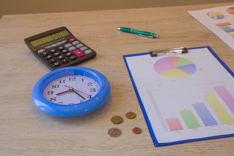 Clock, Calculator, Graphics, Small Change on Table. Business Strategy ...