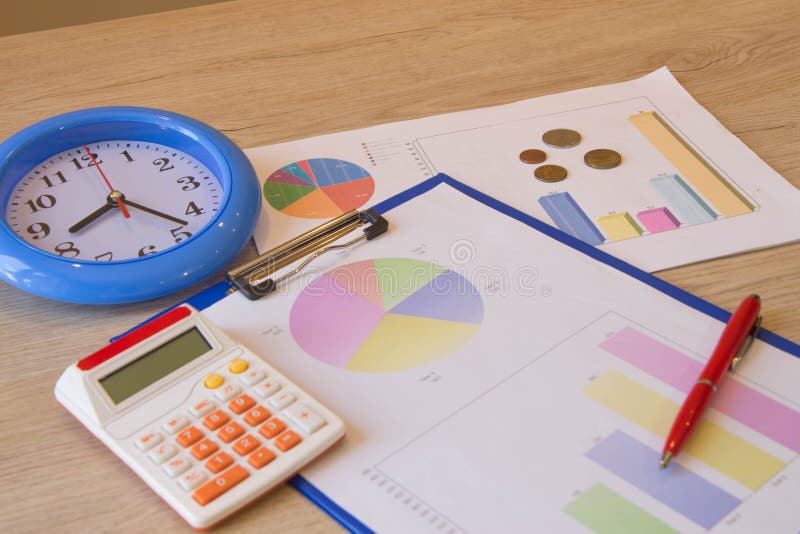 Clock, Calculator, Pen, Graphics on Table, Small Change. Business ...