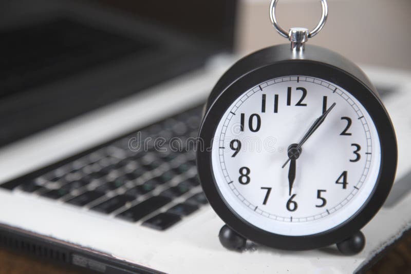 Clock with Computer on the Table Stock Image - Image of notebook ...