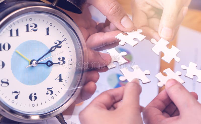 Clock Counting Deadline with Team Putting Up Jigsaw for Business ...