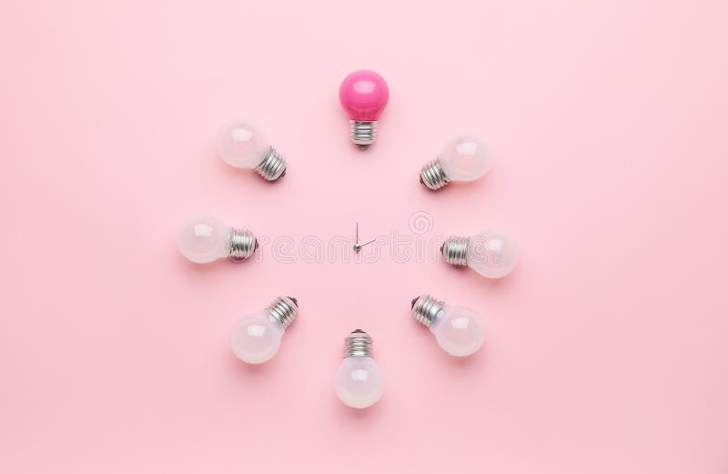 Creative Clock Made of Light Bulbs on Color Background Stock Photo ...
