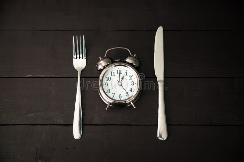 Clock with fork and knife stock photo. Image of fork - 196510700