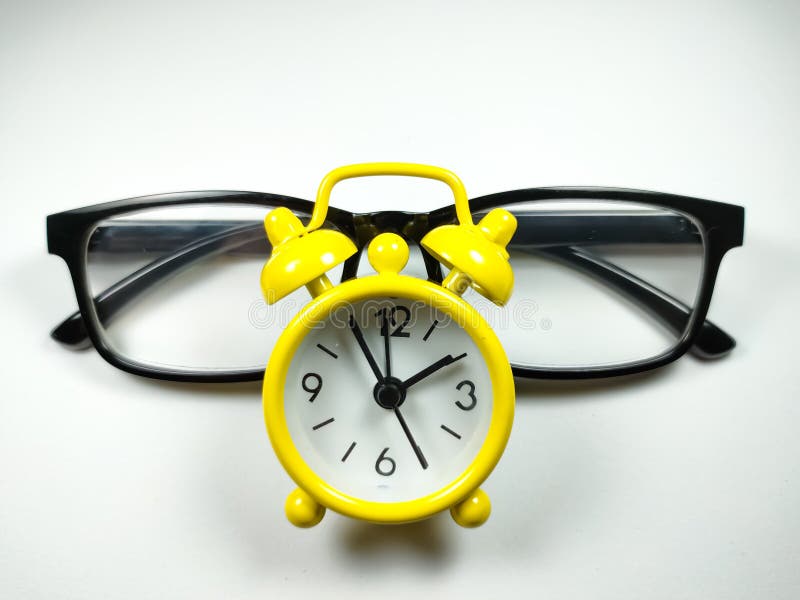 Clock and glasses on table stock photo. Image of frontview - 109474346