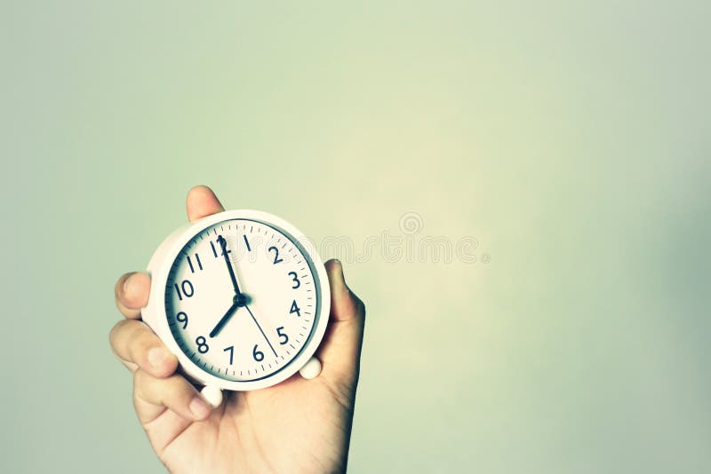 Clock in hand stock image. Image of background, time - 140678241