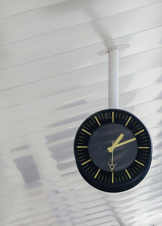 Clock Hanging from Ceiling in Room Stock Photo - Image of hands, wood ...