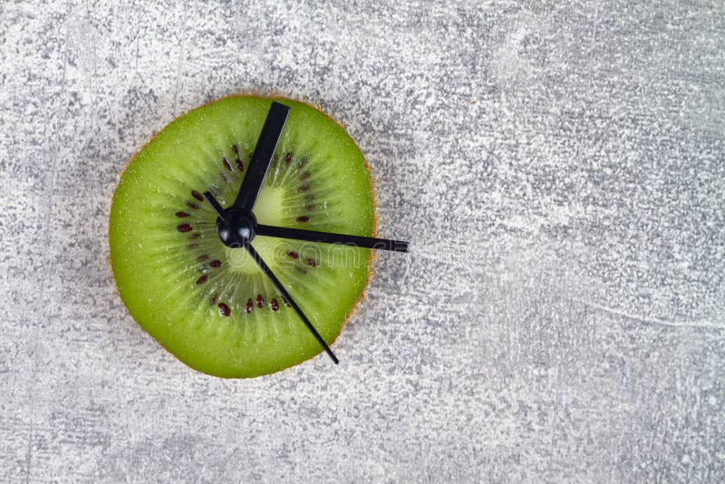 A Clock Made of Green Kiwi Fruit Shows the Time Stock Photo - Image of ...